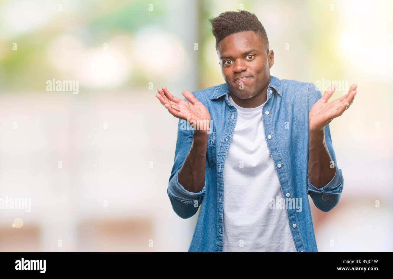 Young african american man over isolated background clueless and ...