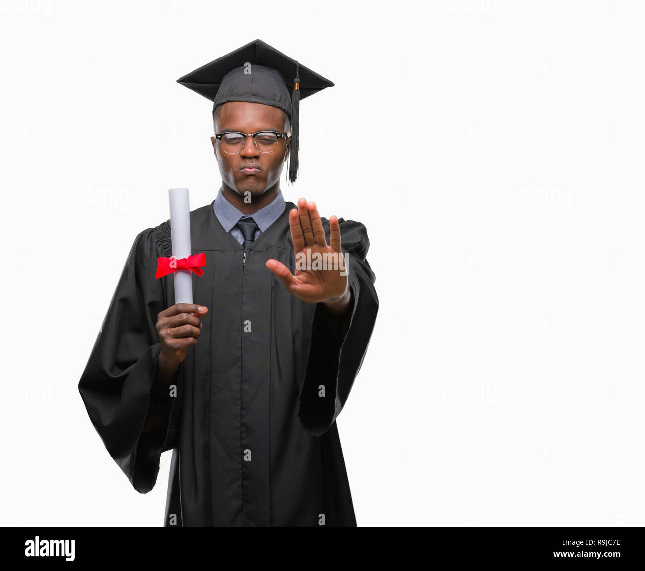 Young graduated african american man holding degree over isolated ...