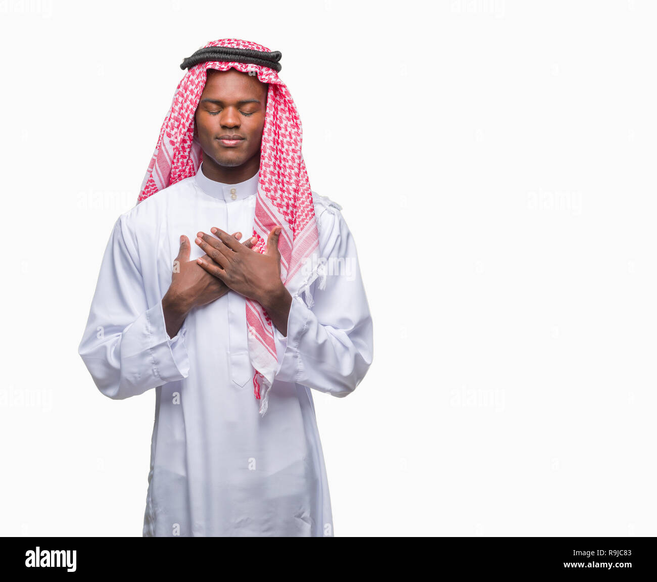 Young arabic african man wearing traditional keffiyeh over isolated ...