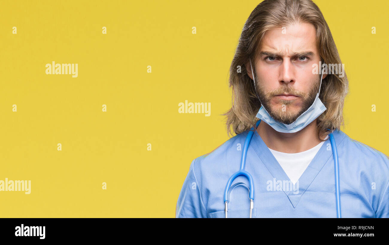 Young handsome doctor man with long hair over isolated background ...