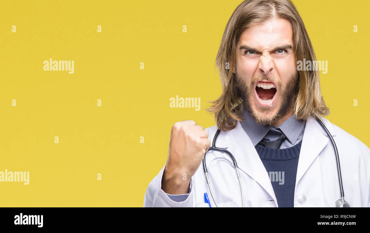 Young handsome doctor man with long hair over isolated background angry ...