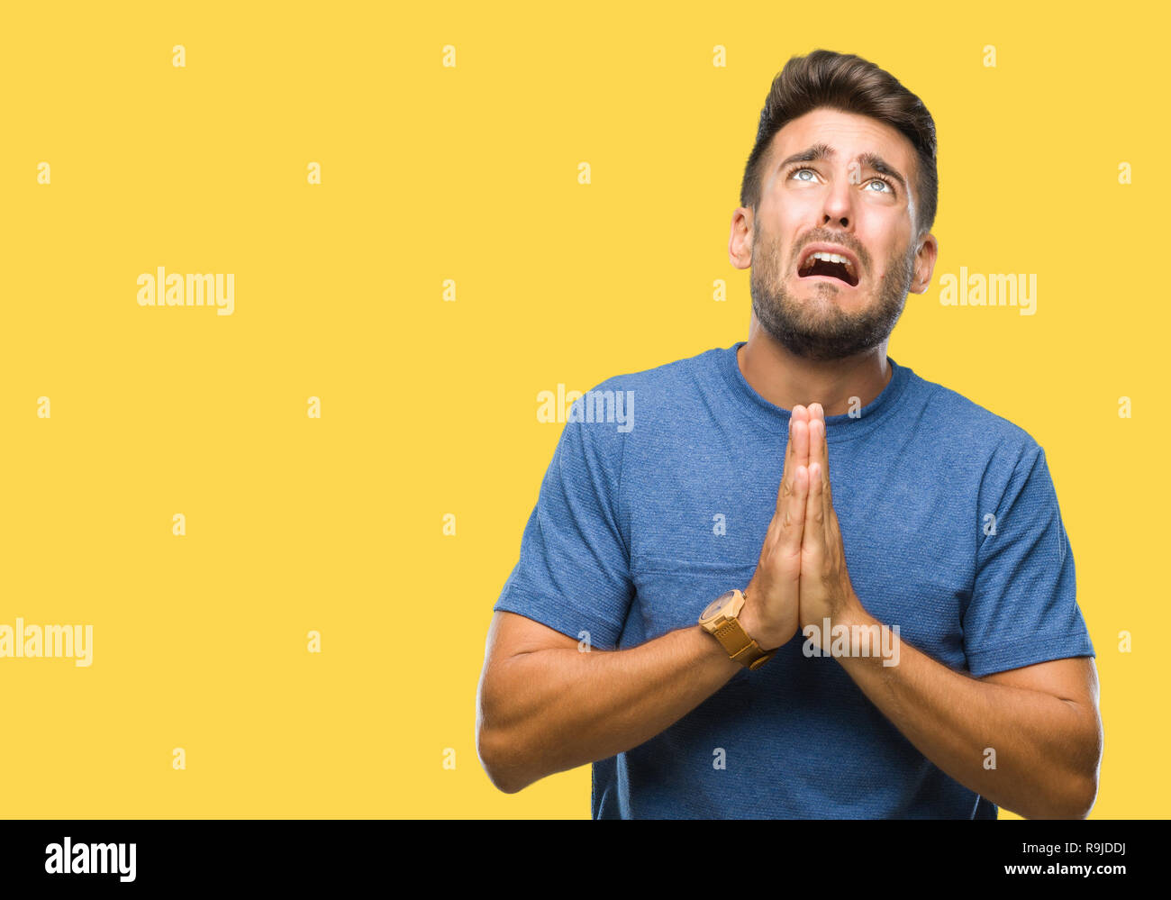 Young handsome man over isolated background begging and praying with ...