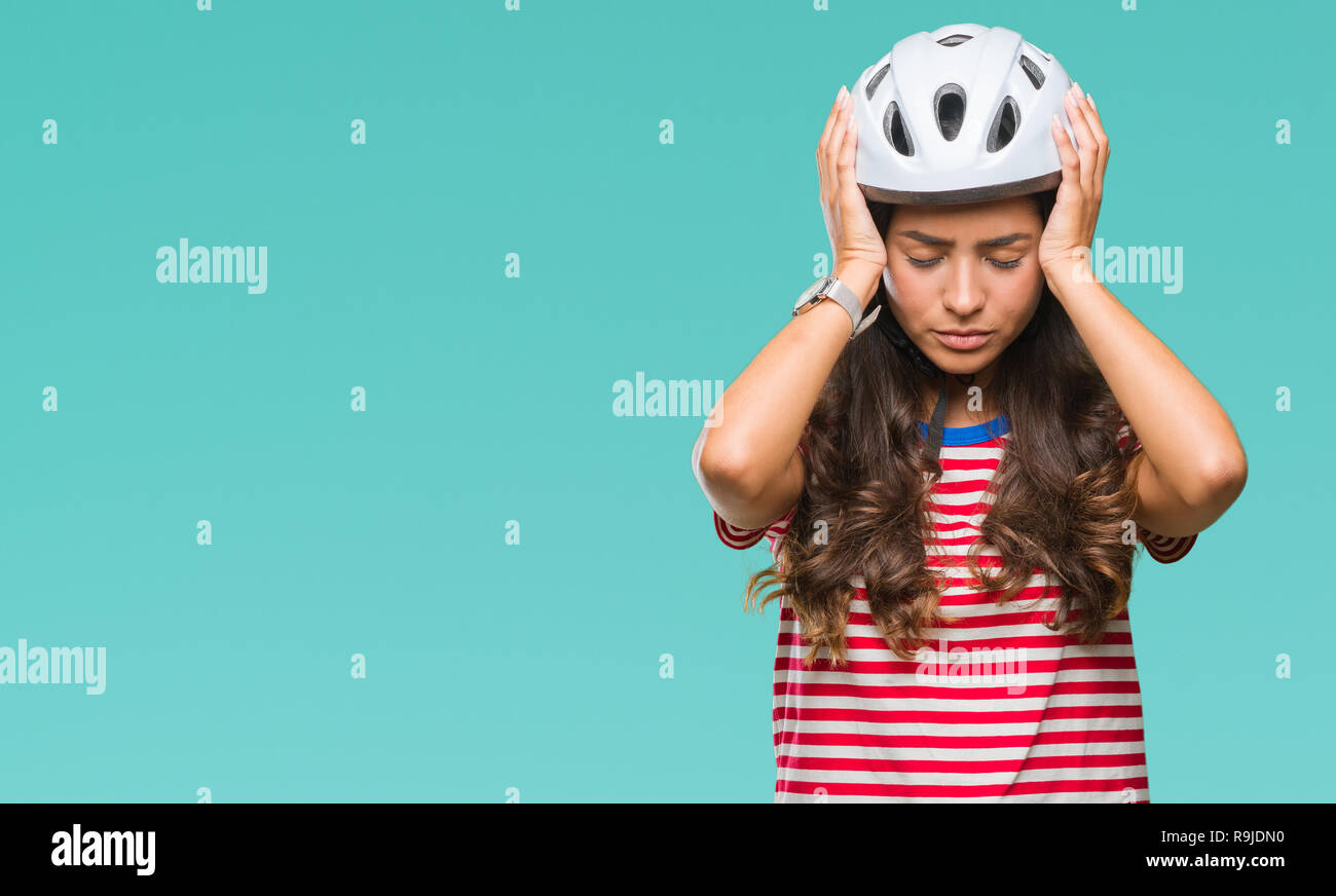 Young arab cyclist woman wearing safety helmet over isolated background ...