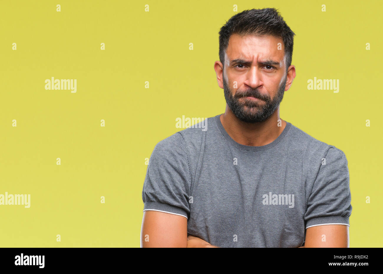 Adult hispanic man over isolated background skeptic and nervous ...