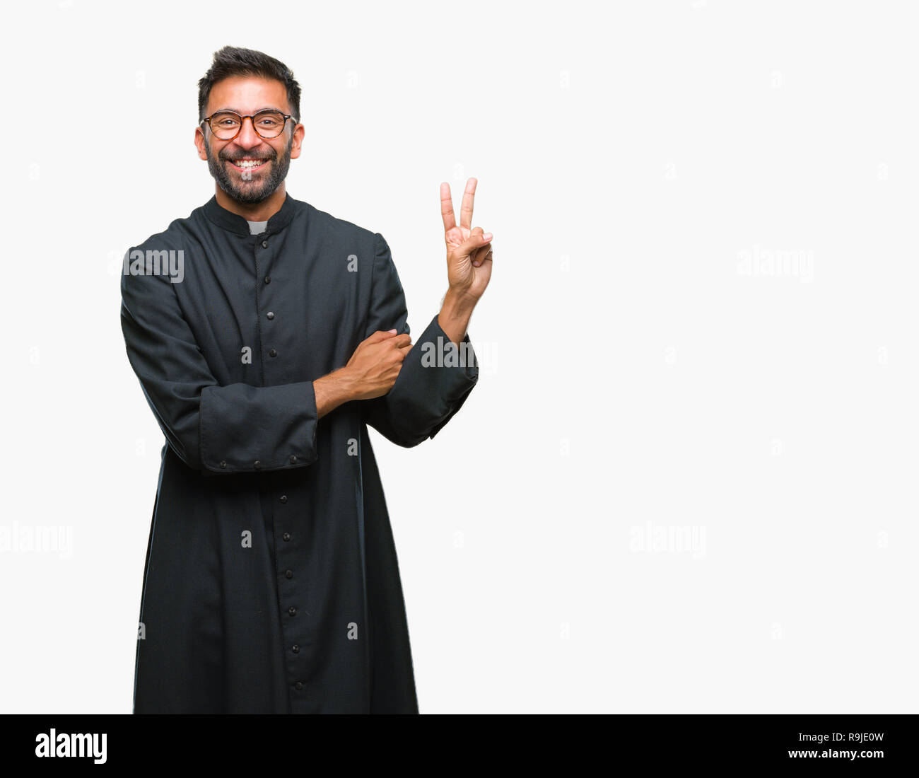 Adult hispanic catholic priest man over isolated background smiling ...