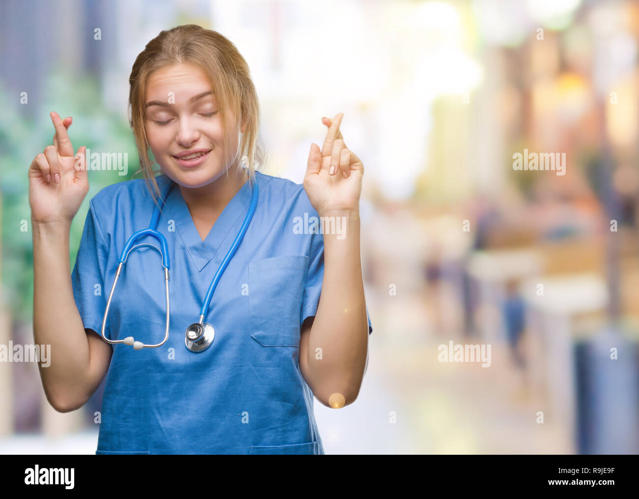 Young caucasian doctor woman wearing surgeon uniform over isolated ...