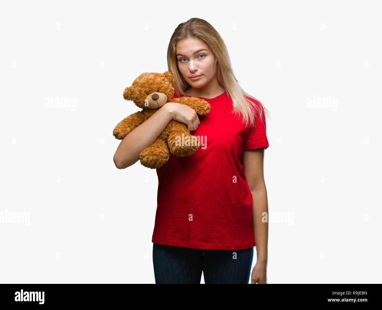 Young caucasian woman holding cute teddy bear over isolated background ...