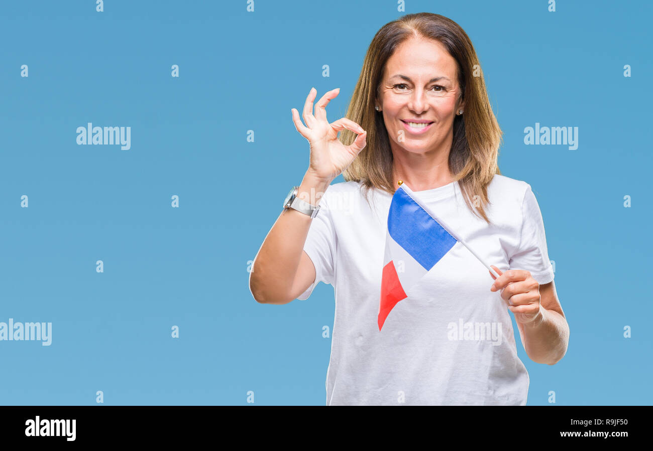 Middle age hispanic woman holding flag of France over isolated ...