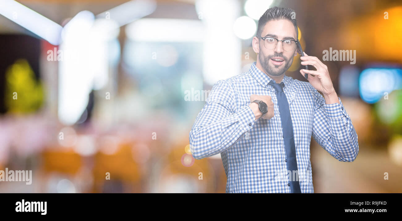 Young business man talking on the phone over isolated background with ...