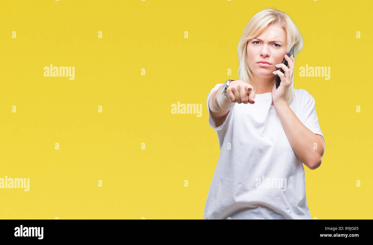 Young beautiful blonde woman calling and talking on smartphone over ...