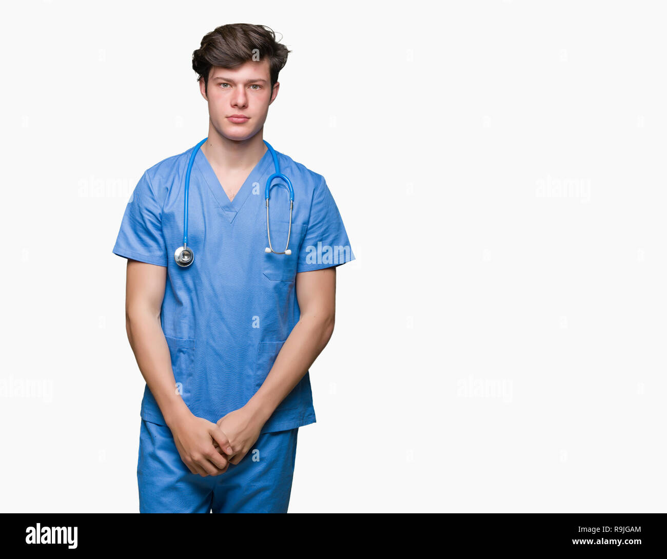 Young doctor wearing medical uniform over isolated background Relaxed ...