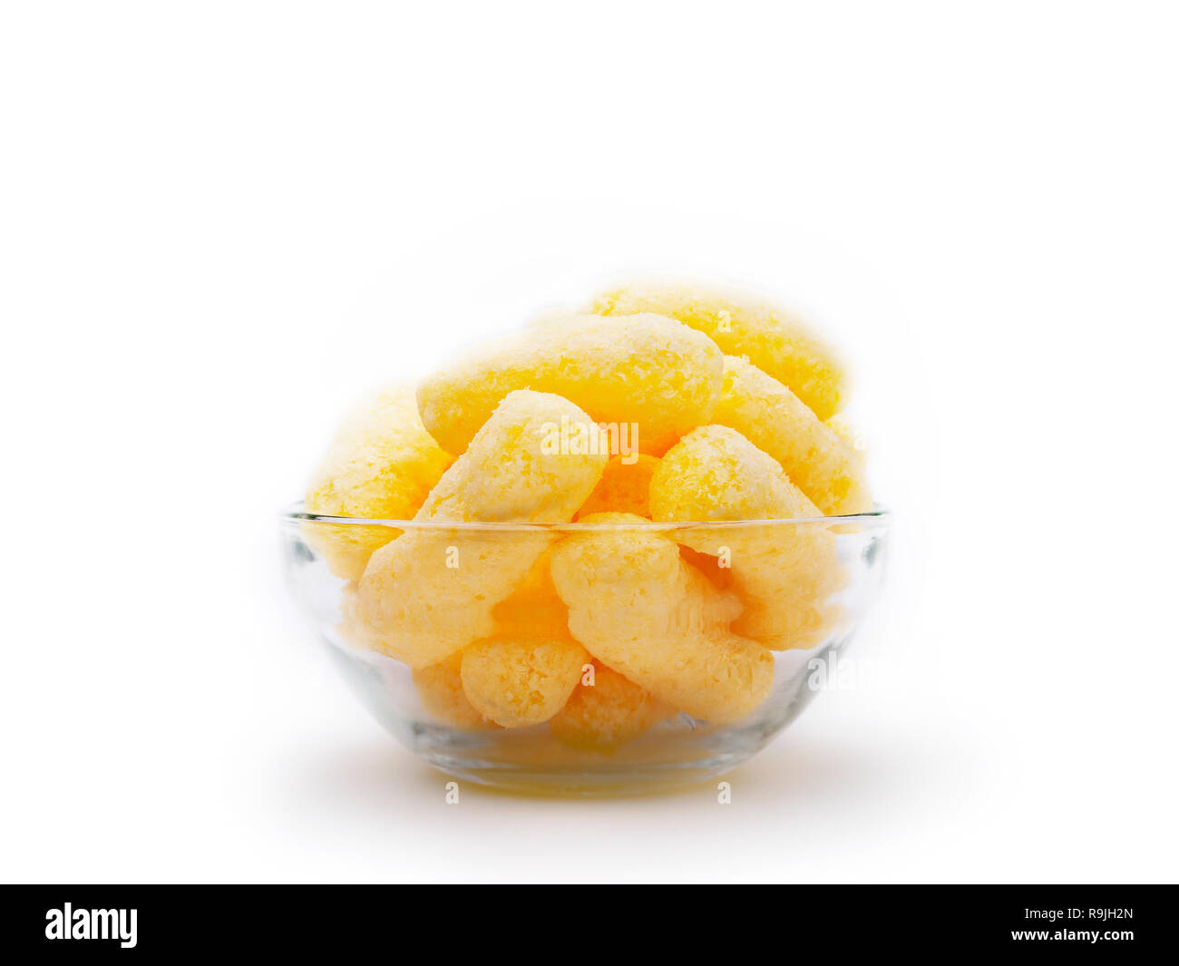 Yellow Corn Puffs in a Glass Bowl Isolated On White Background. Crunchy ...