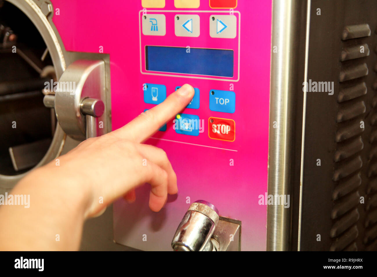Female confectioner in chef uniform producing ice cream with ice cream ...