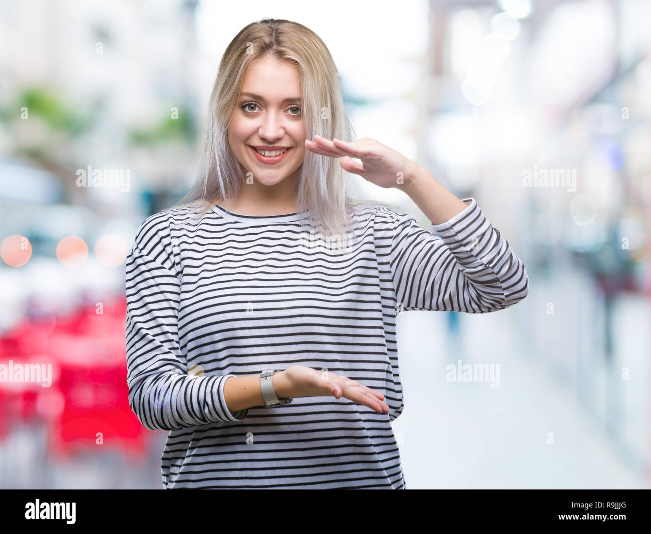 Young blonde woman over isolated background gesturing with hands ...
