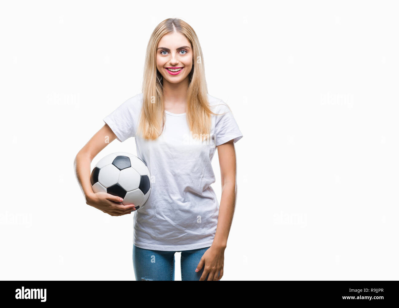 Young beautiful blonde woman holding soccer ball over isolated ...