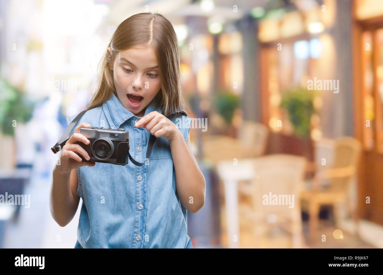 Young beautiful girl taking photos using vintage camera over isolated ...