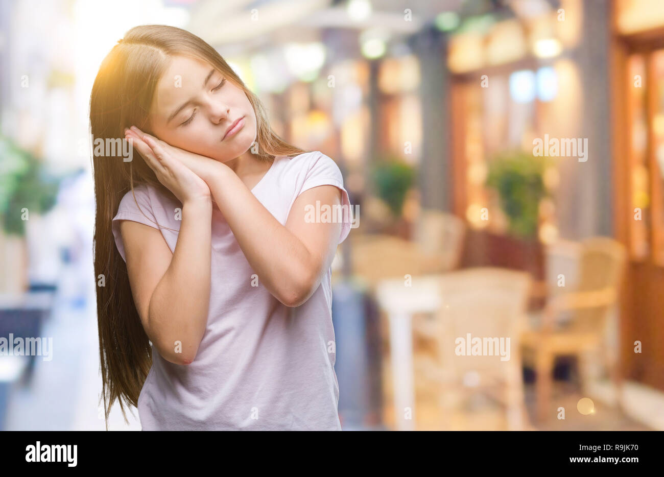 Young beautiful girl over isolated background sleeping tired dreaming ...