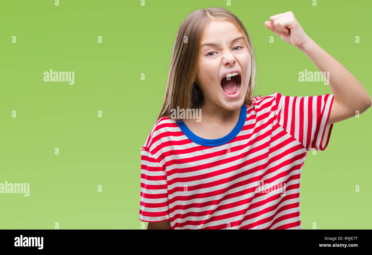 Young beautiful girl over isolated background angry and mad raising ...