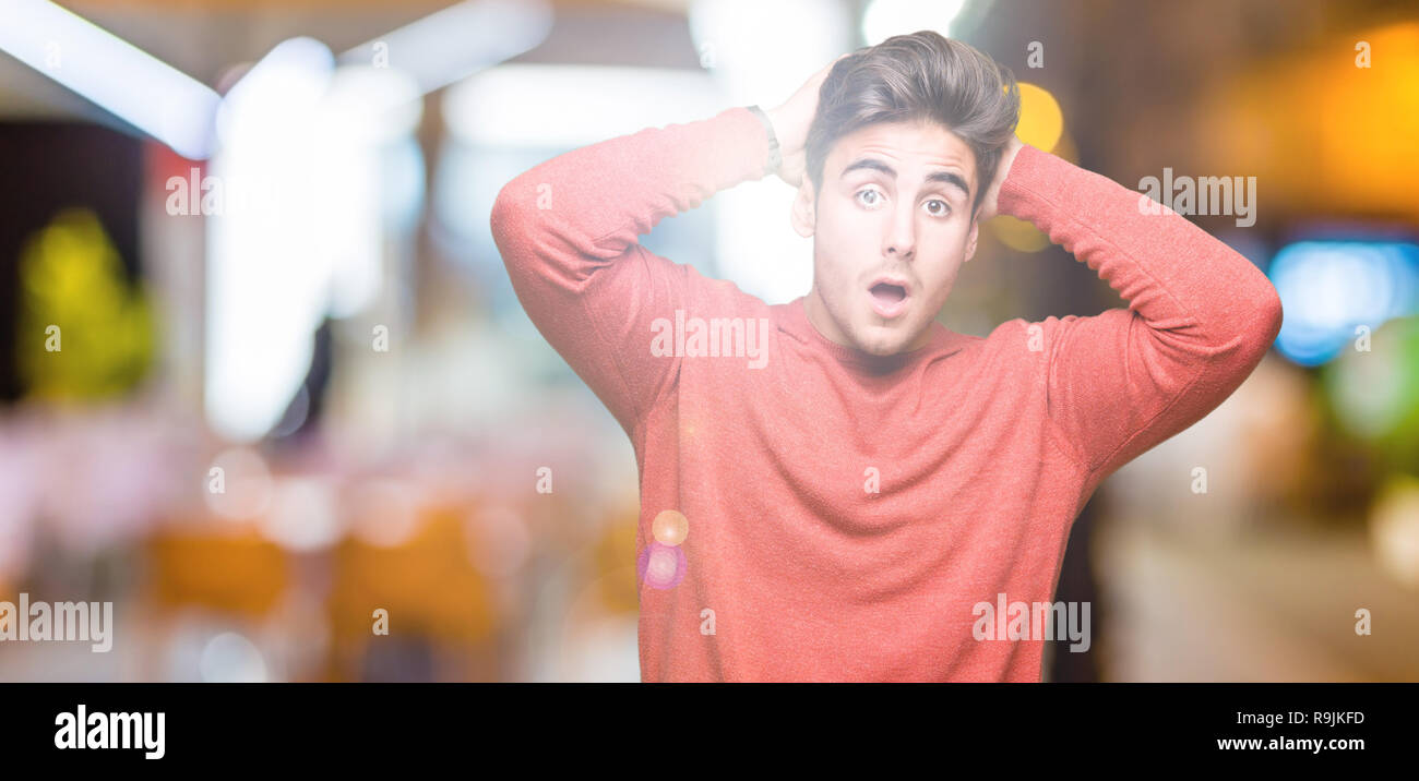 Young handsome man over isolated background Crazy and scared with hands ...