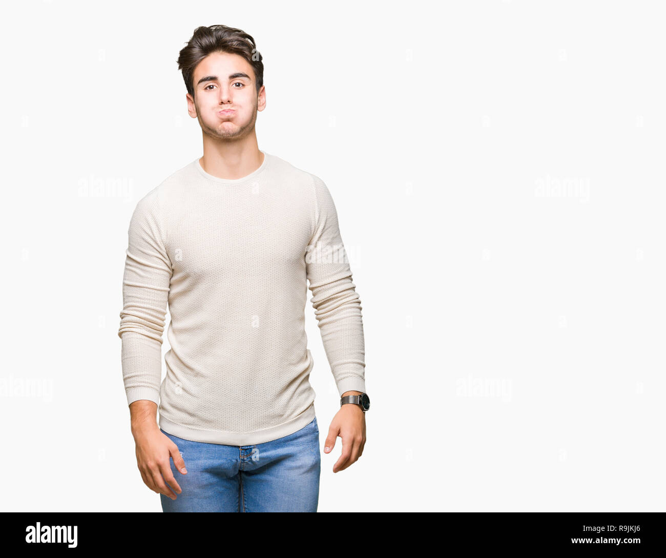 Young handsome man over isolated background puffing cheeks with funny ...
