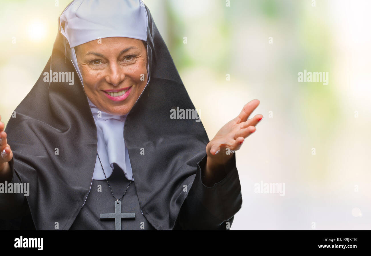 Middle age senior christian catholic nun woman over isolated background ...
