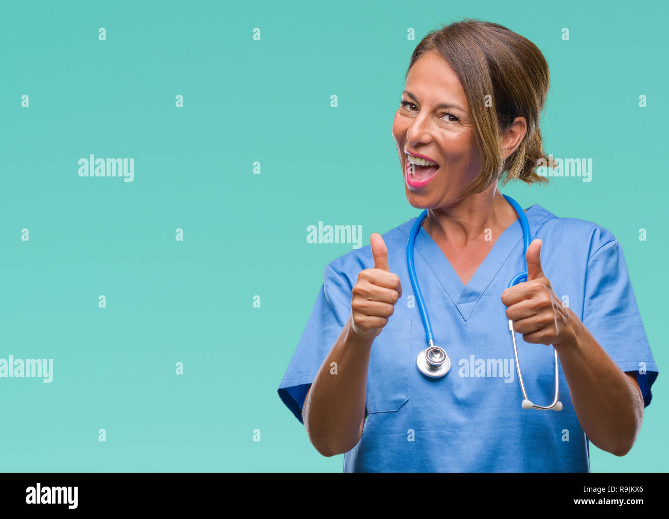 Middle age senior nurse doctor woman over isolated background pointing ...