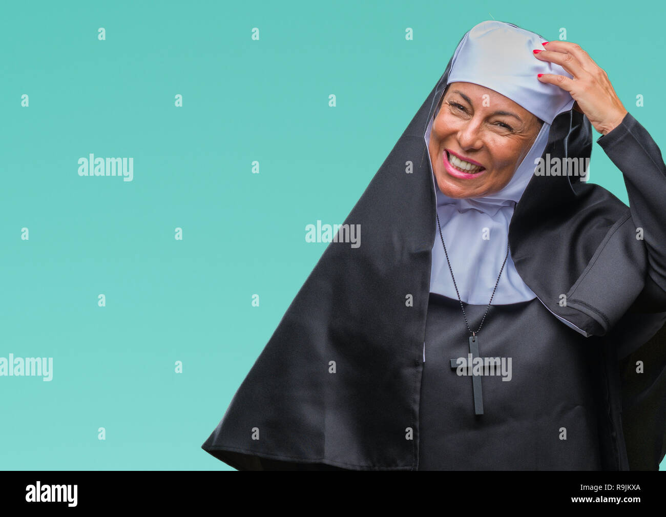 Middle age senior christian catholic nun woman over isolated background ...