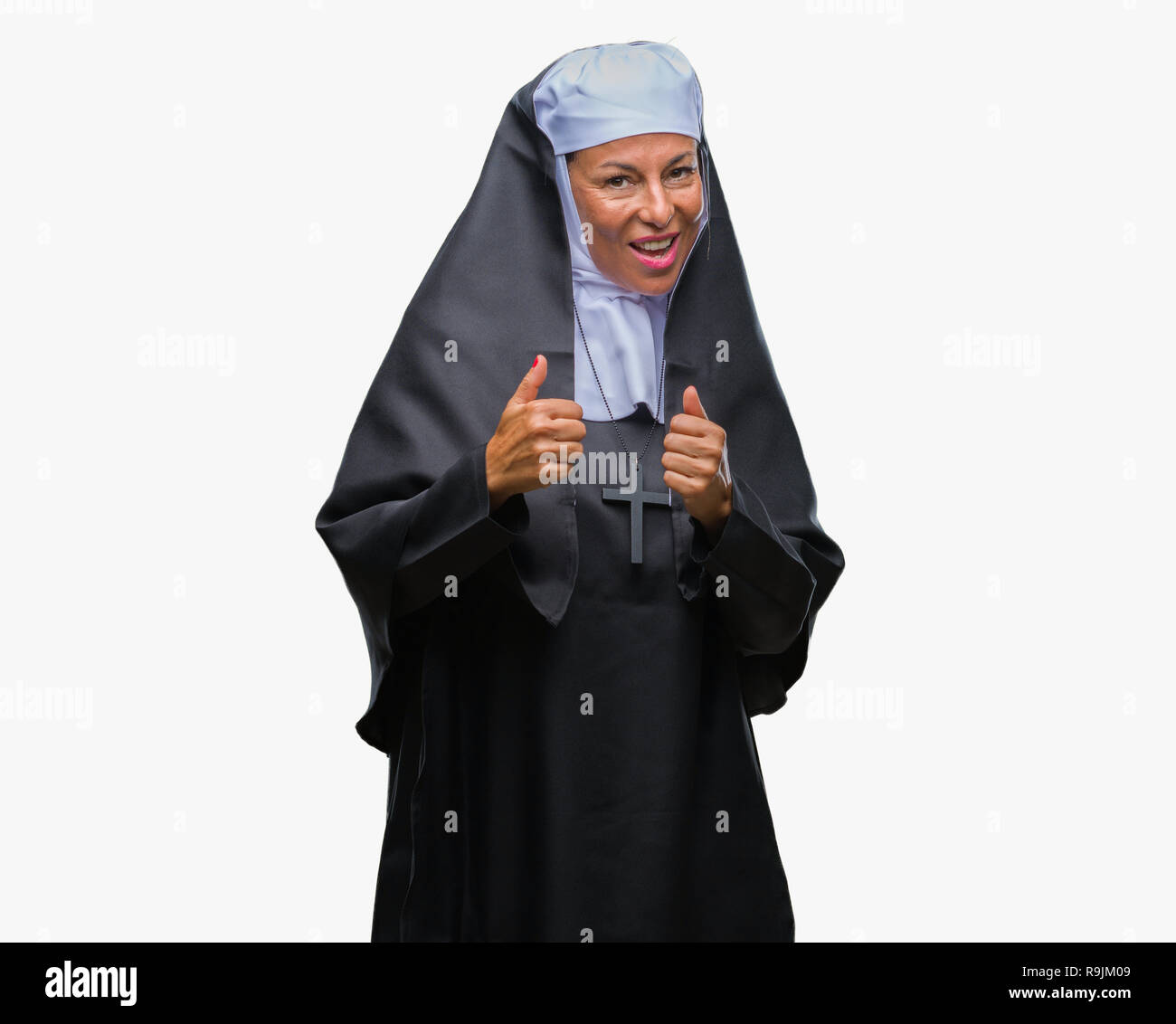 Middle age senior christian catholic nun woman over isolated background ...