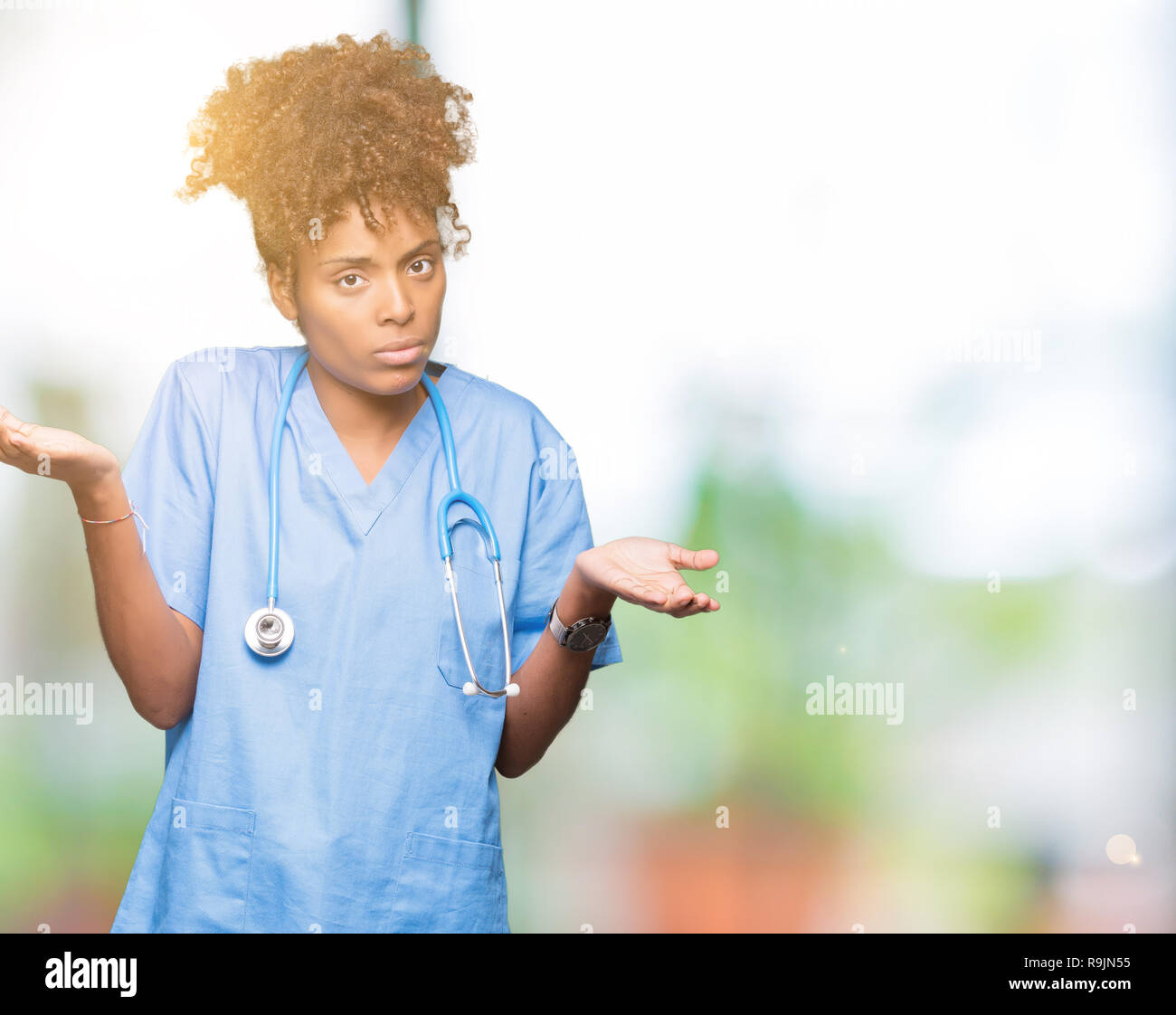 Young african american doctor woman over isolated background clueless ...