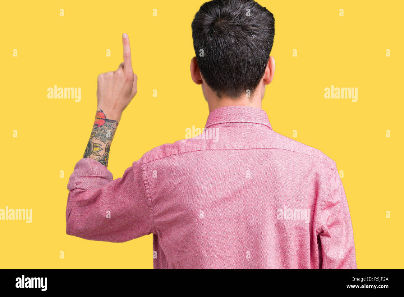 Young handsome man wearing pink shirt over isolated background Posing ...
