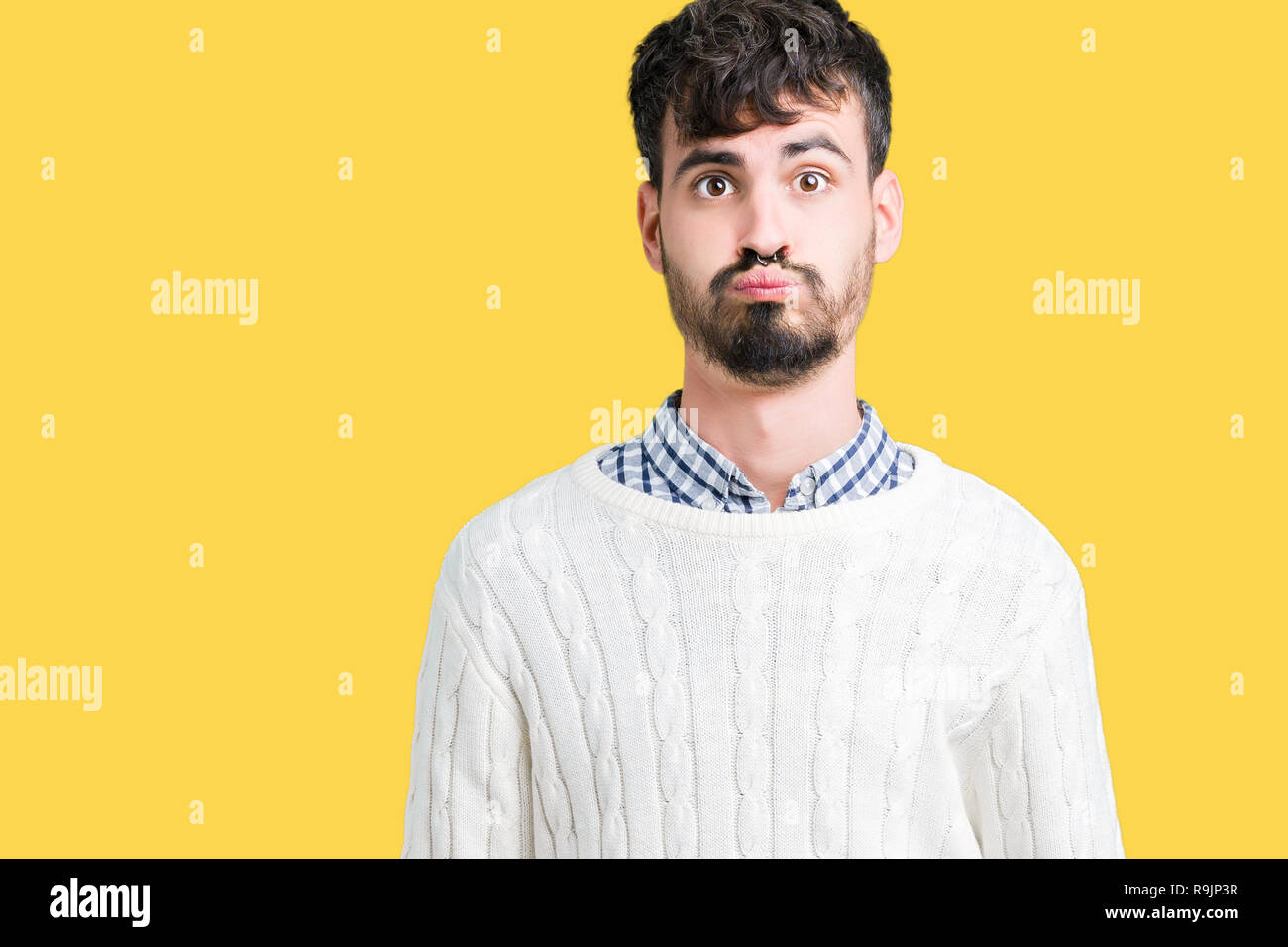 Young handsome man wearing winter sweater over isolated background ...