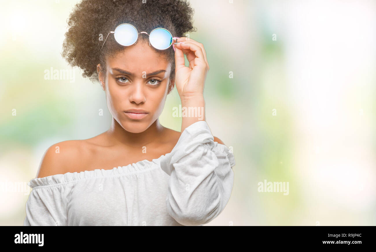 Young afro american woman wearing sunglasses over isolated background ...