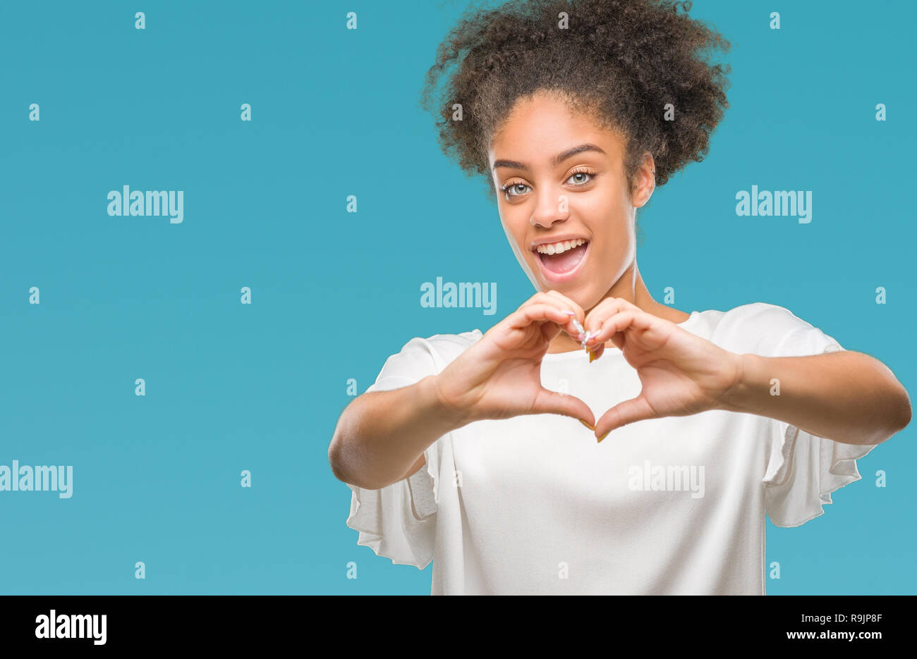 Young afro american woman over isolated background smiling in love ...