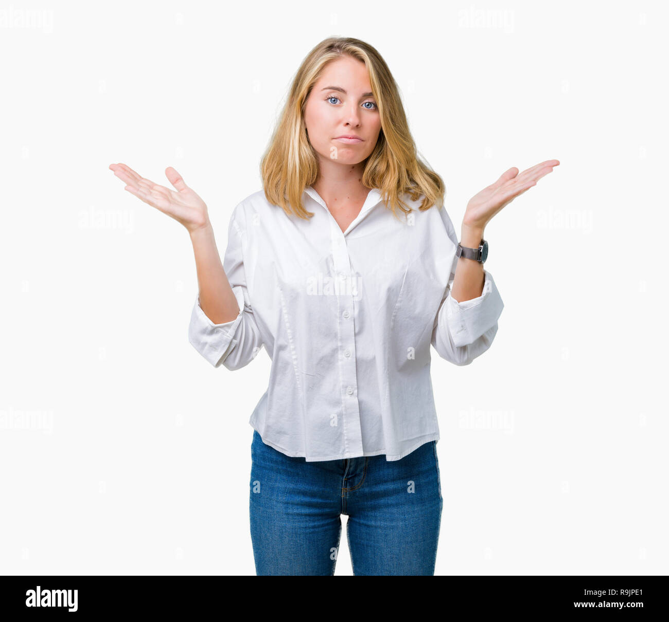 Beautiful young business woman over isolated background clueless and ...