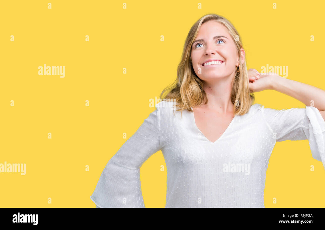 Beautiful young elegant woman over isolated background stretching back ...