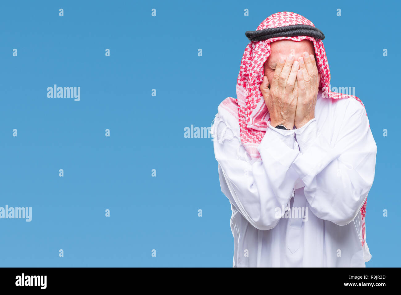 Senior arab man wearing keffiyeh over isolated background with sad ...