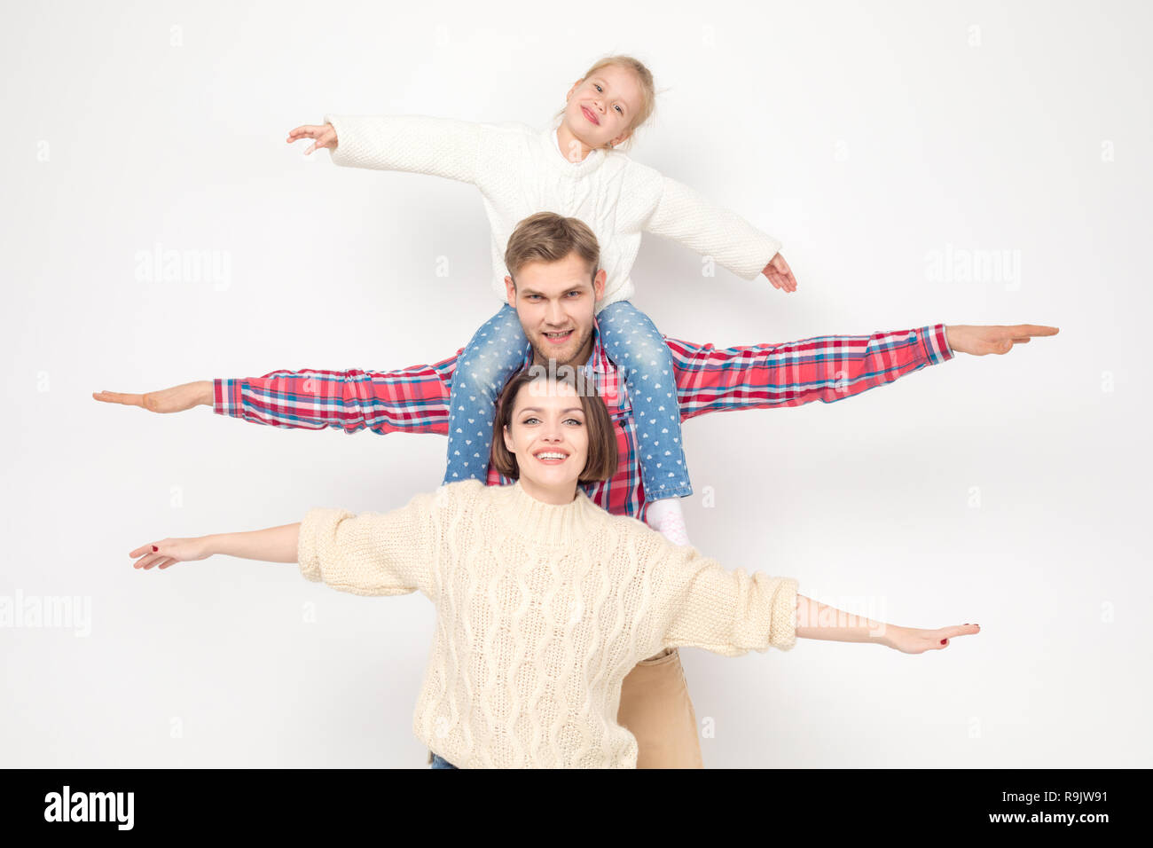 Happy family of three having fun and standing on white background Stock ...