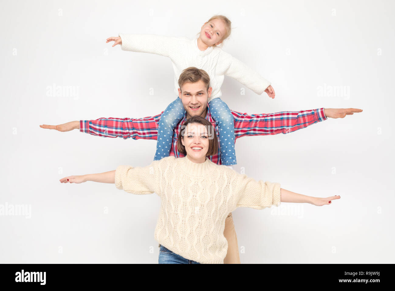 Happy family of three having fun and standing on white background Stock ...