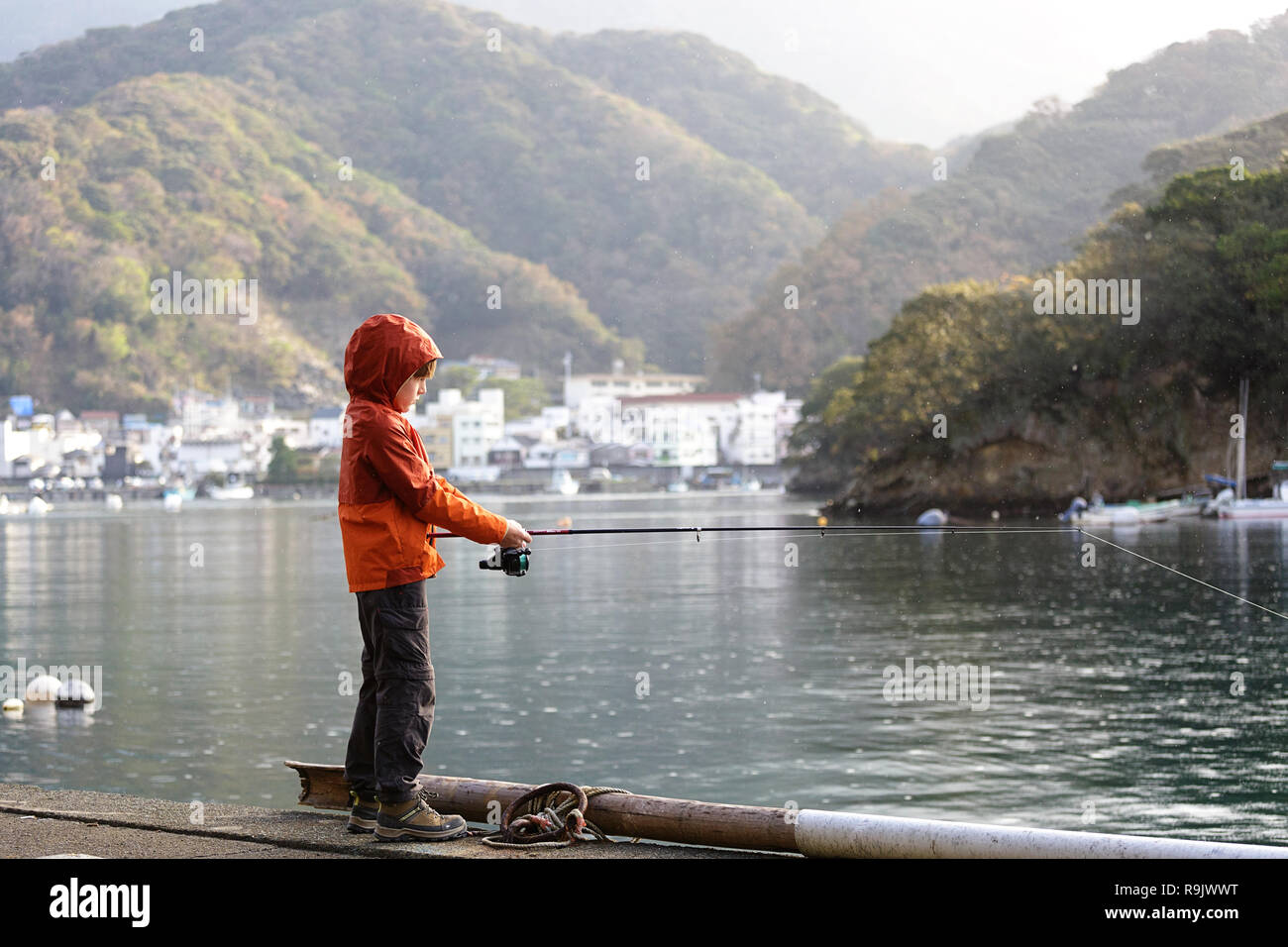 Young boy fishing off a dock, Japan, Honshu Stock Photo - Alamy