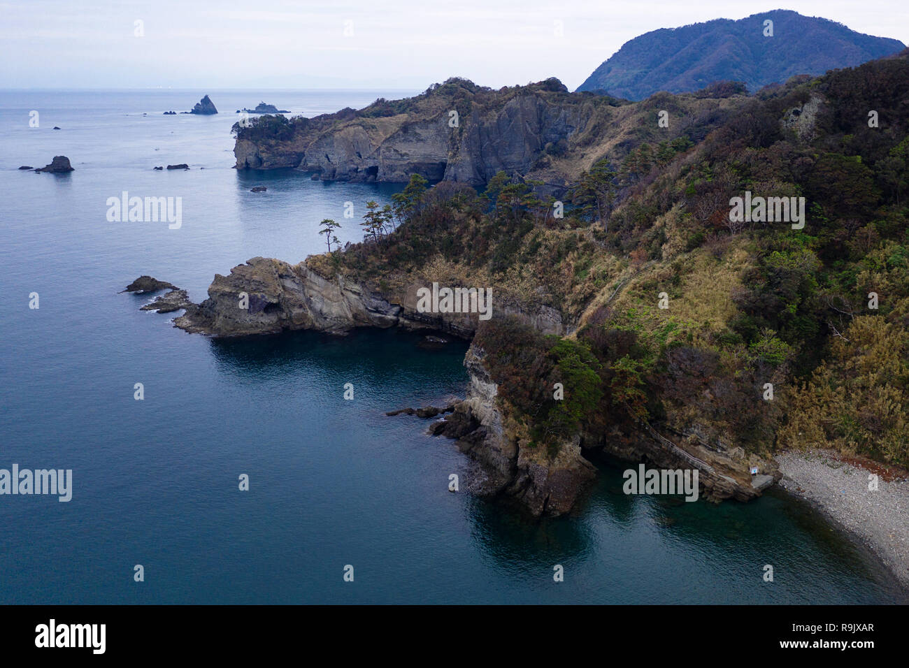 Aerial view of scenic rock formations at Futo beach, taken by a drone ...