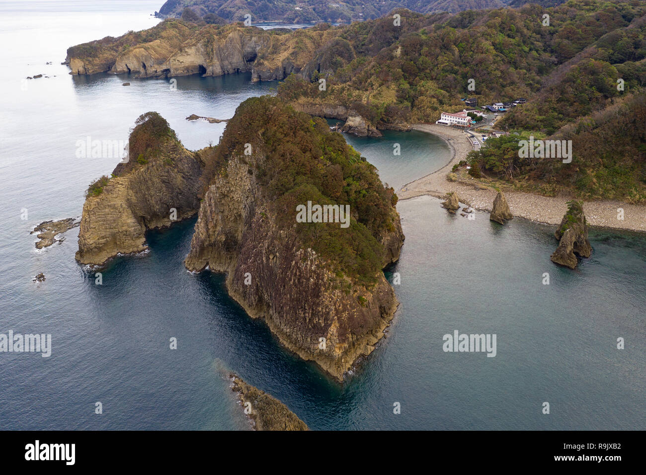 Aerial view of scenic rock formations at Futo beach, taken by a drone ...