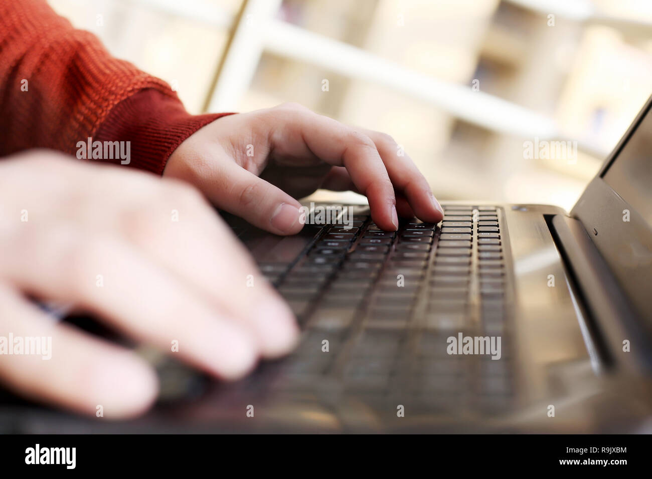 Picture of boy hand using laptop Stock Photo - Alamy