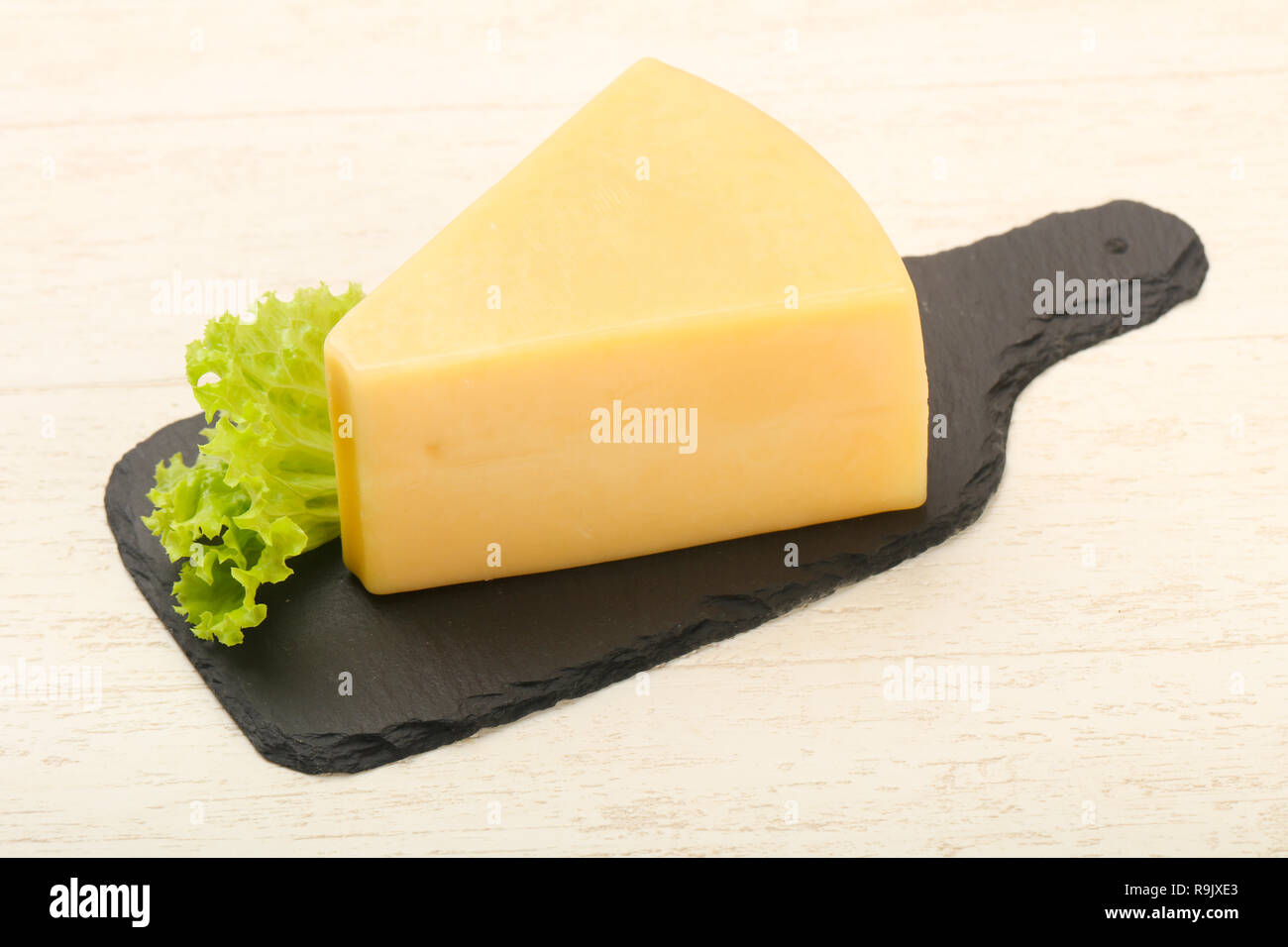 Parmesan cheese triangle Stock Photo - Alamy