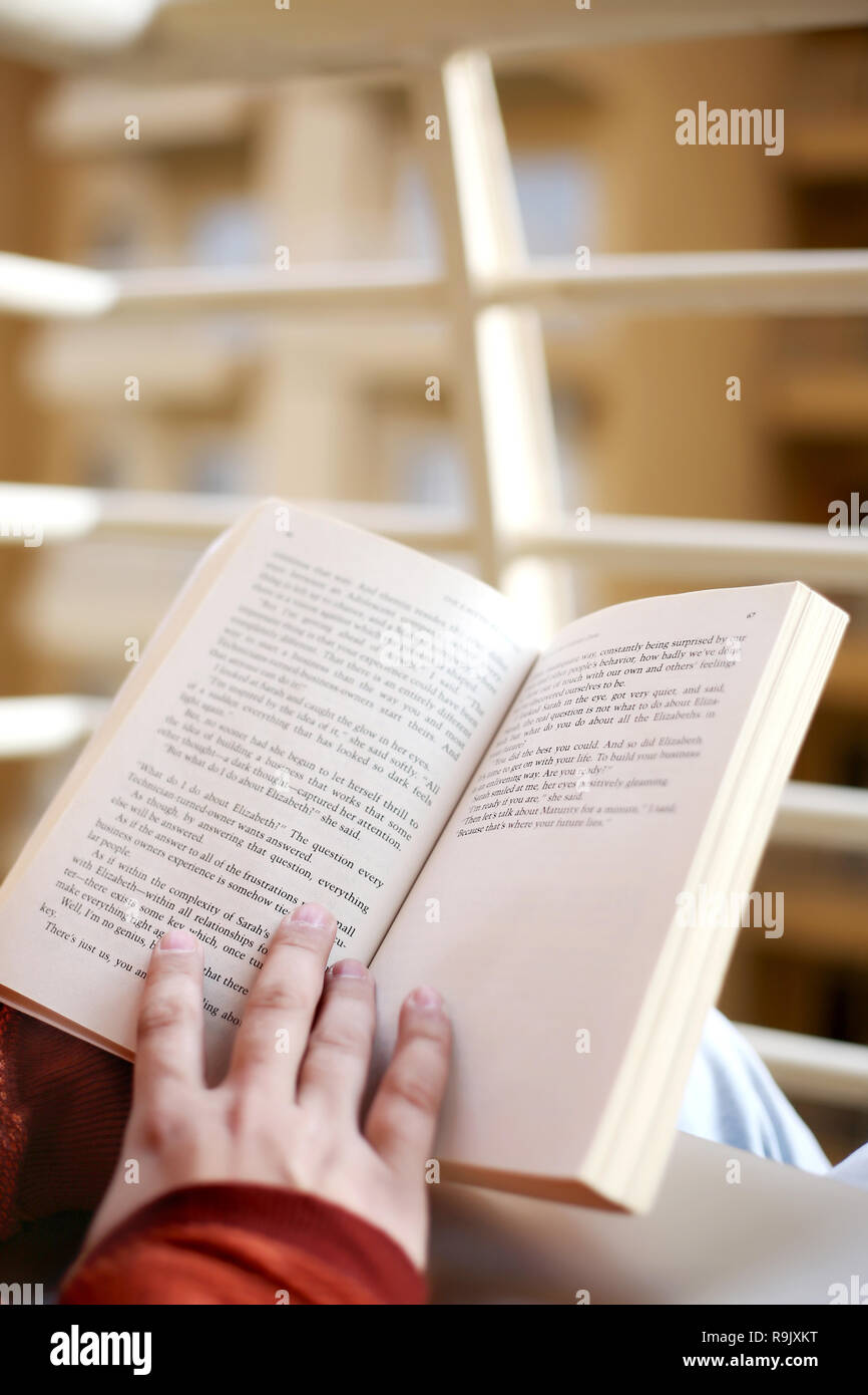 Boy is holding book in hand with reading Stock Photo - Alamy