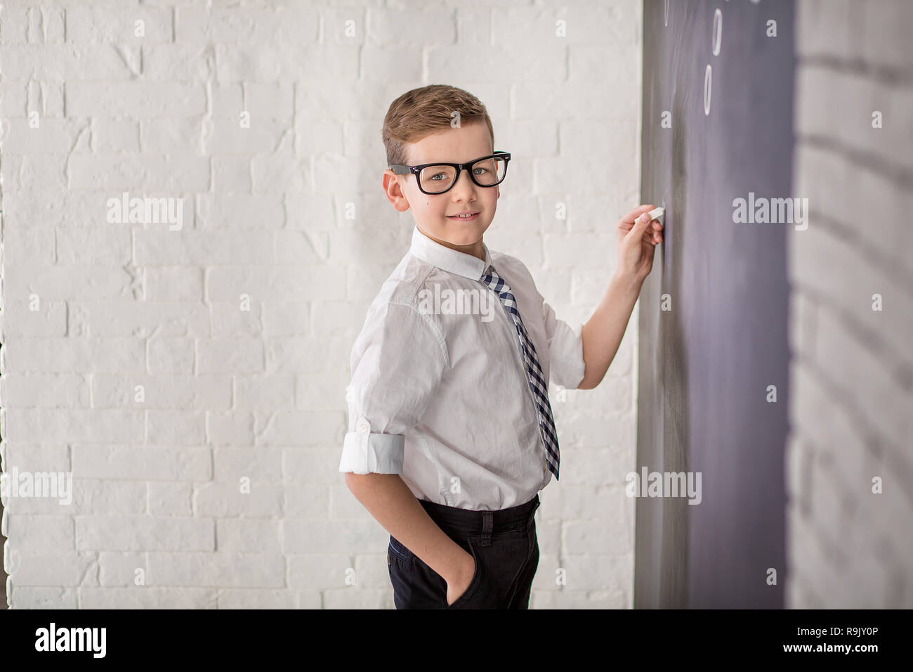 Handsome school boy in googles white shirt tie standing close to school ...