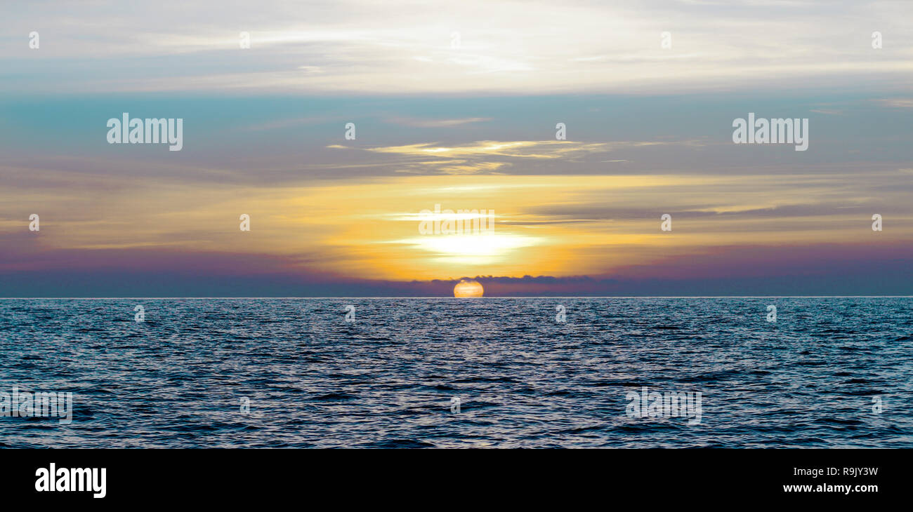 First sunbeams on the horizon Stock Photo - Alamy