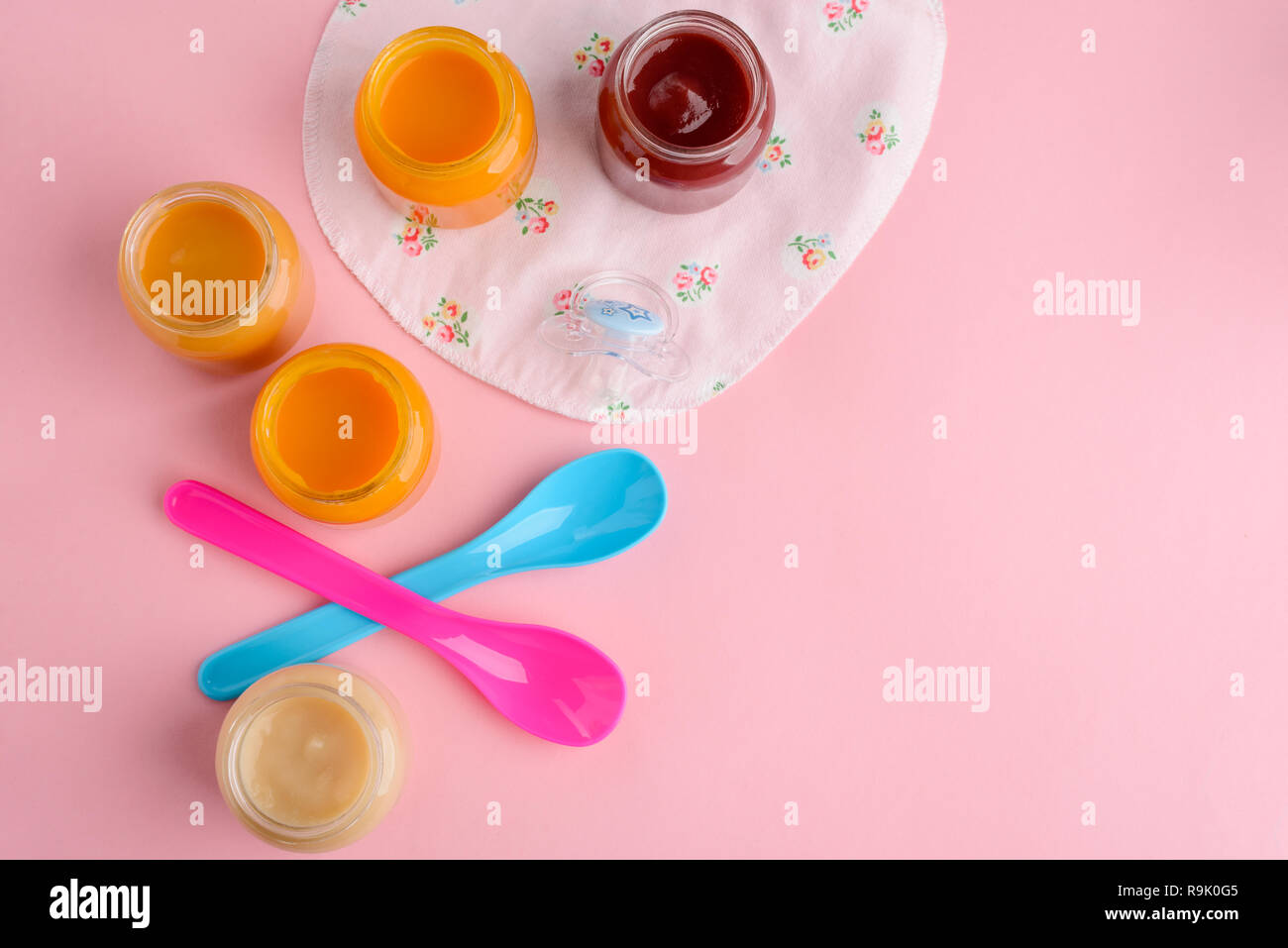 Baby food on pink background Stock Photo - Alamy