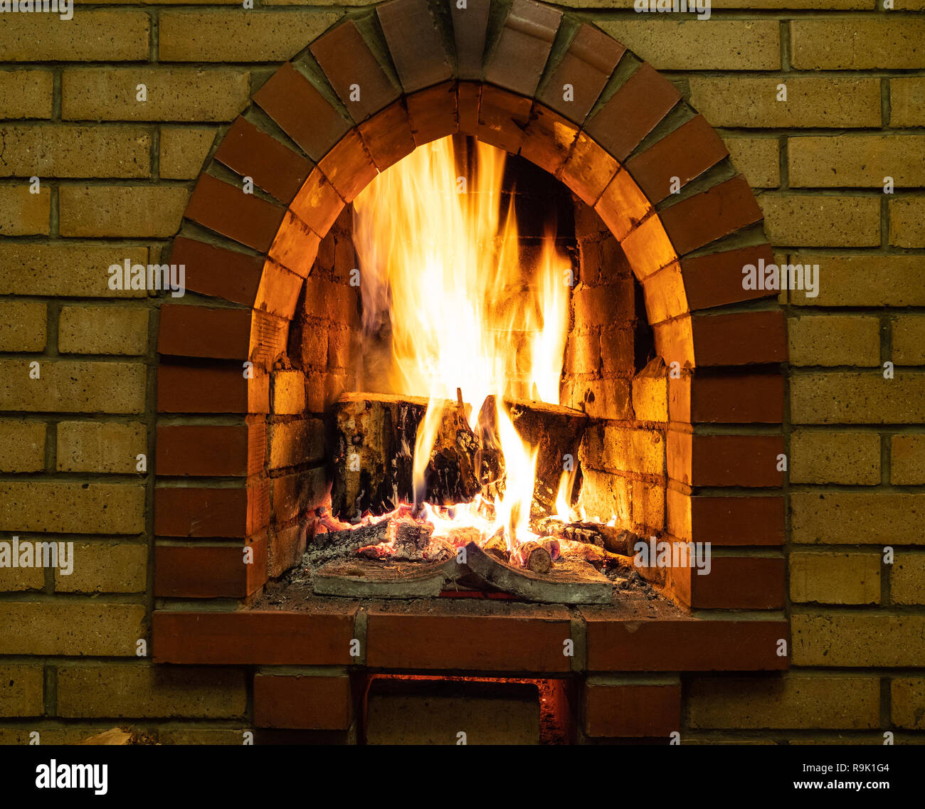 front view of stone fireplace with fire in rural house Stock Photo - Alamy