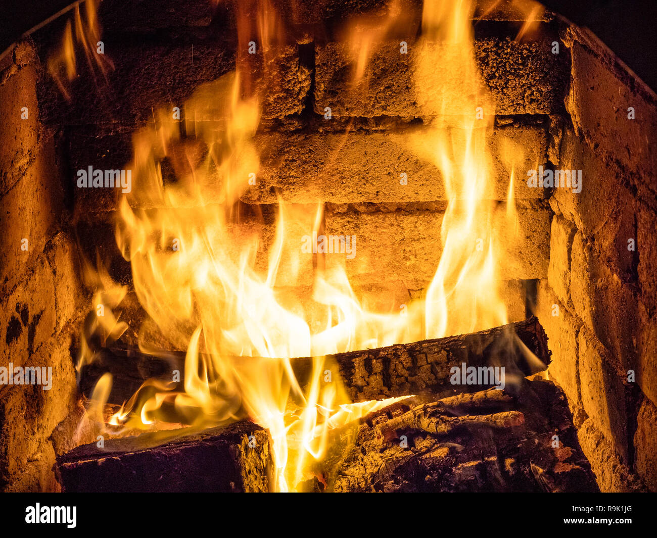 fire in stone hearth in rural house close up Stock Photo - Alamy
