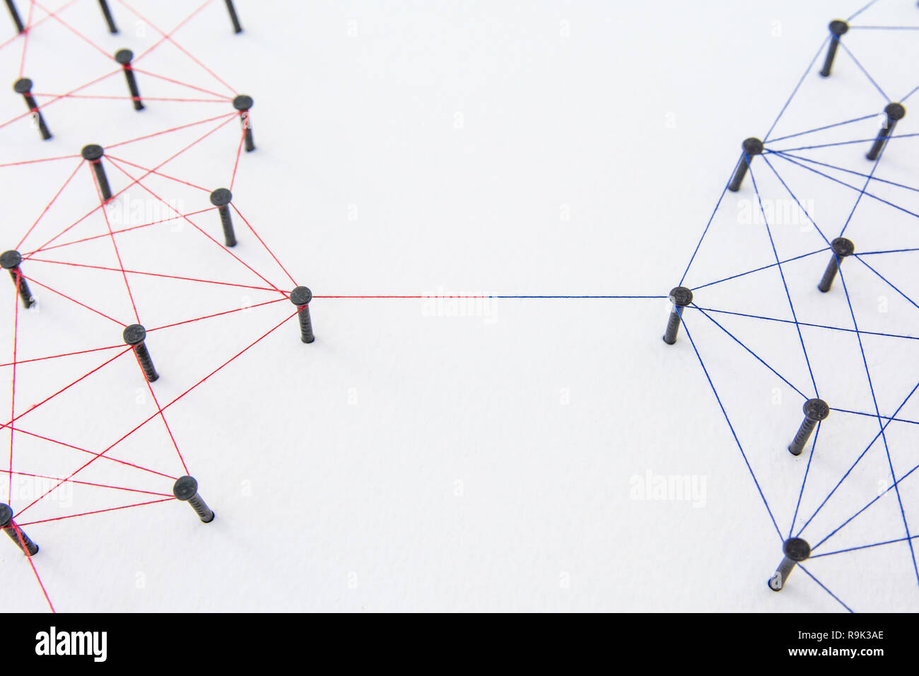 Connecting networks concept - two network connected with yarn red and ...